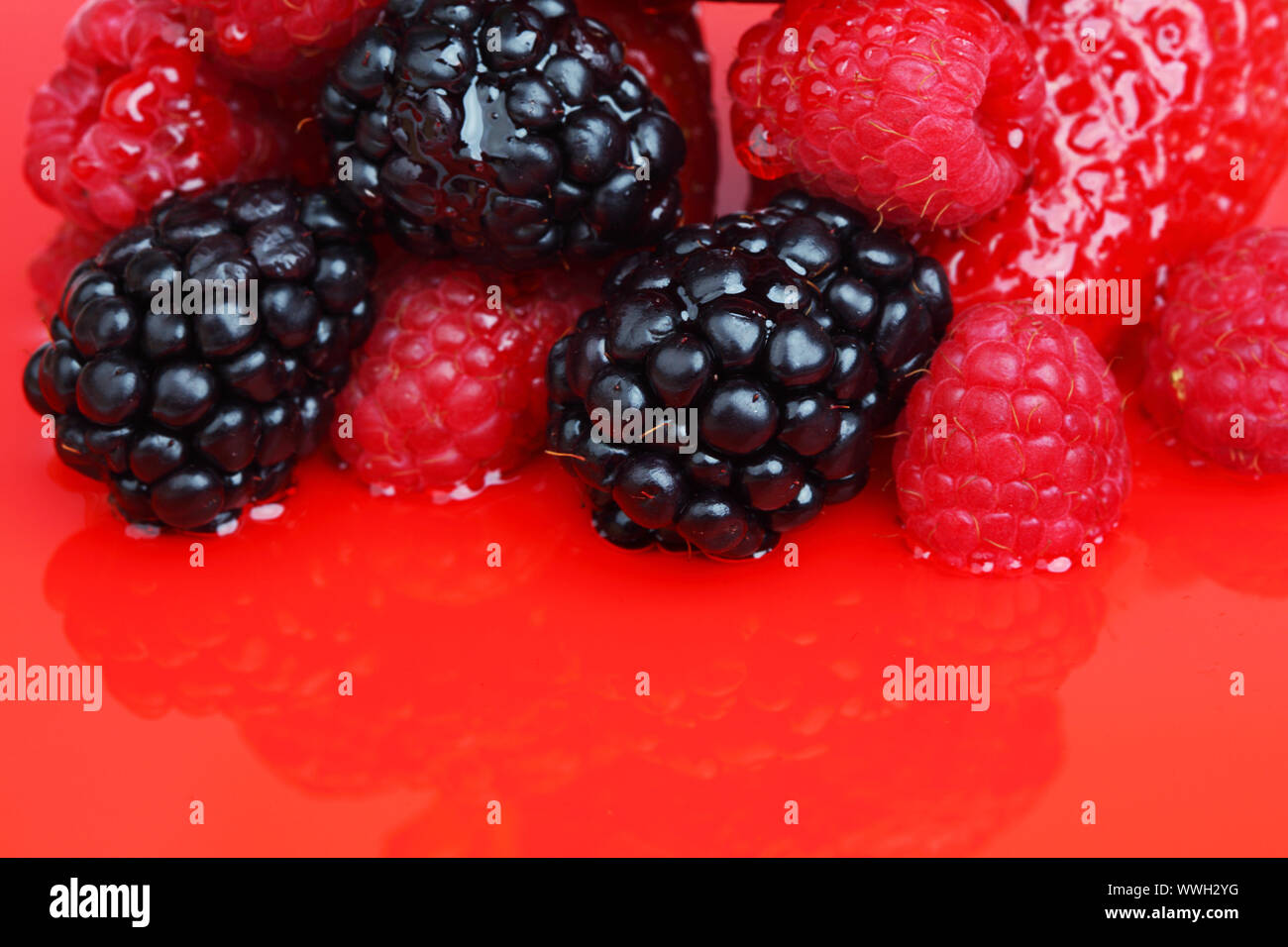 berry mixed pile in syrup isolated on white Stock Photo - Alamy