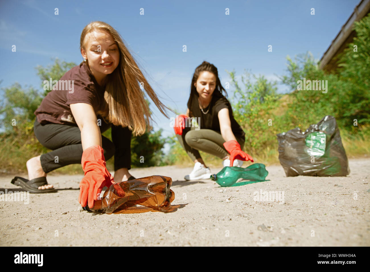 Clean our home together. Group of volunteers tidying up rubbish on ...