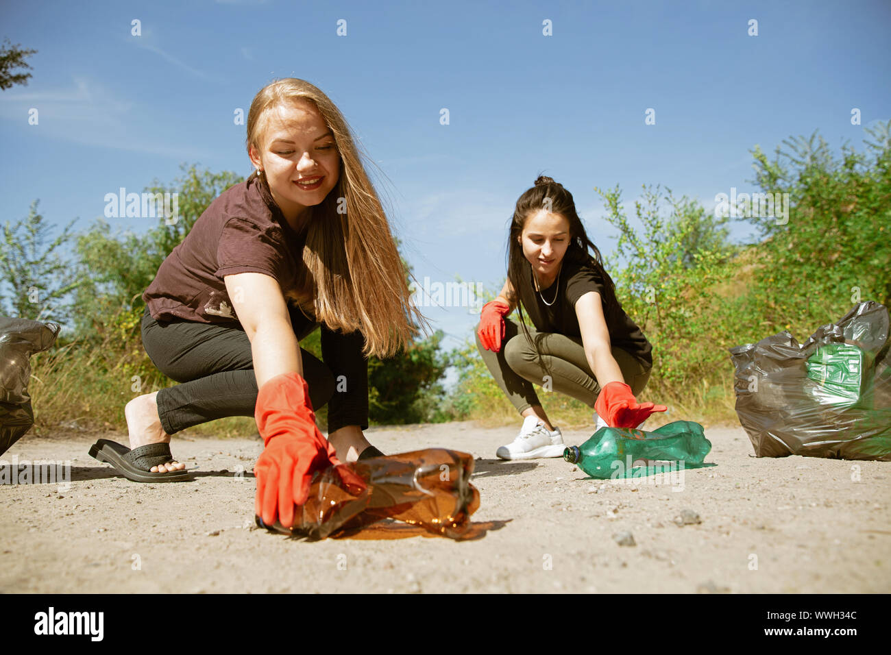 Clean our home together. Group of volunteers tidying up rubbish on ...