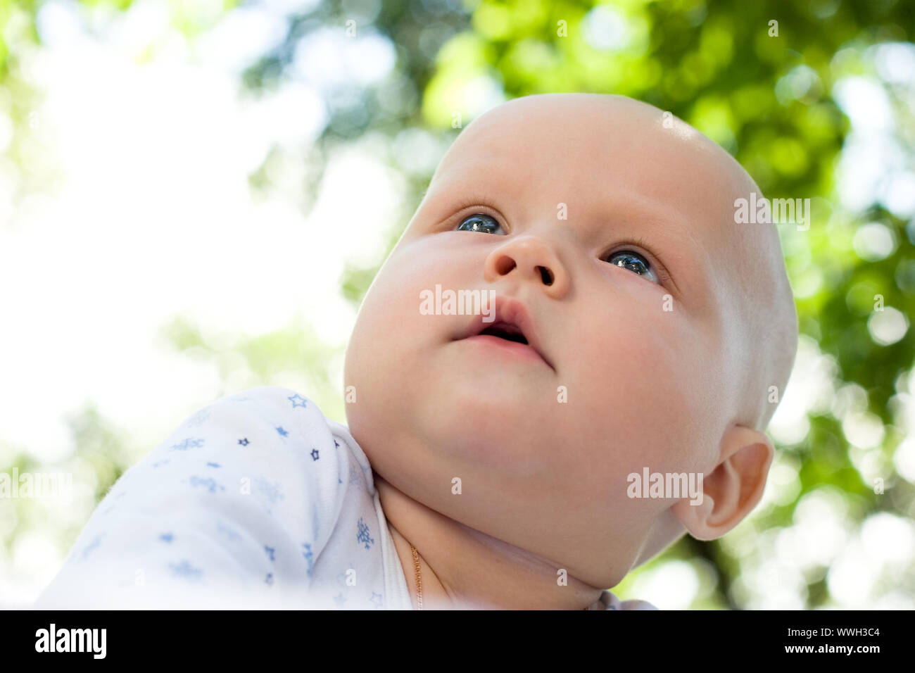 Little baby enjoying summer in a garden Stock Photo - Alamy