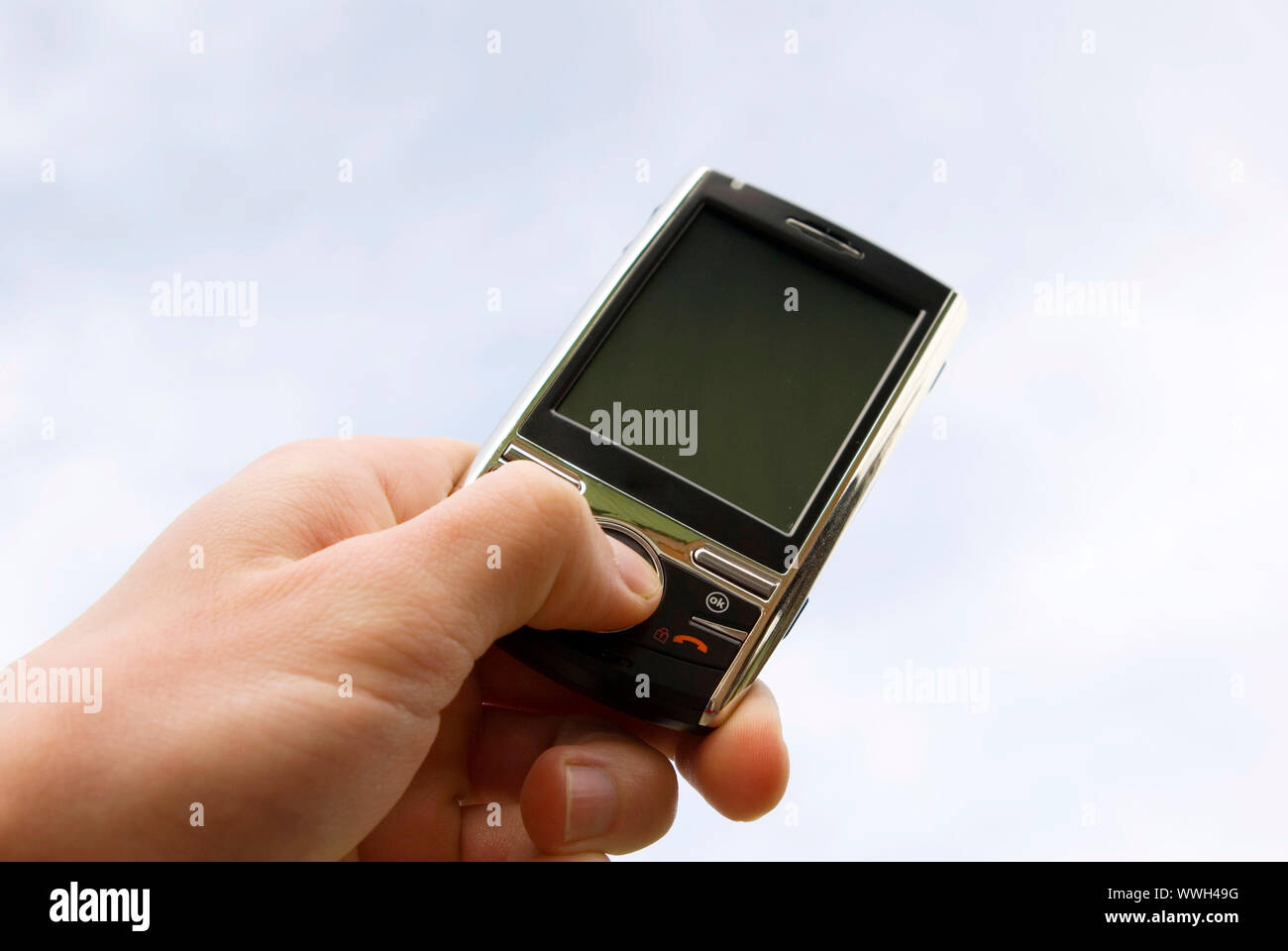 a hand holding a mobile phone for support Stock Photo - Alamy