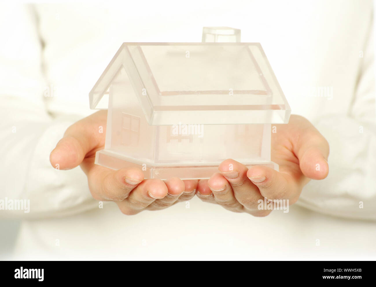 The house in human hands on white Stock Photo - Alamy