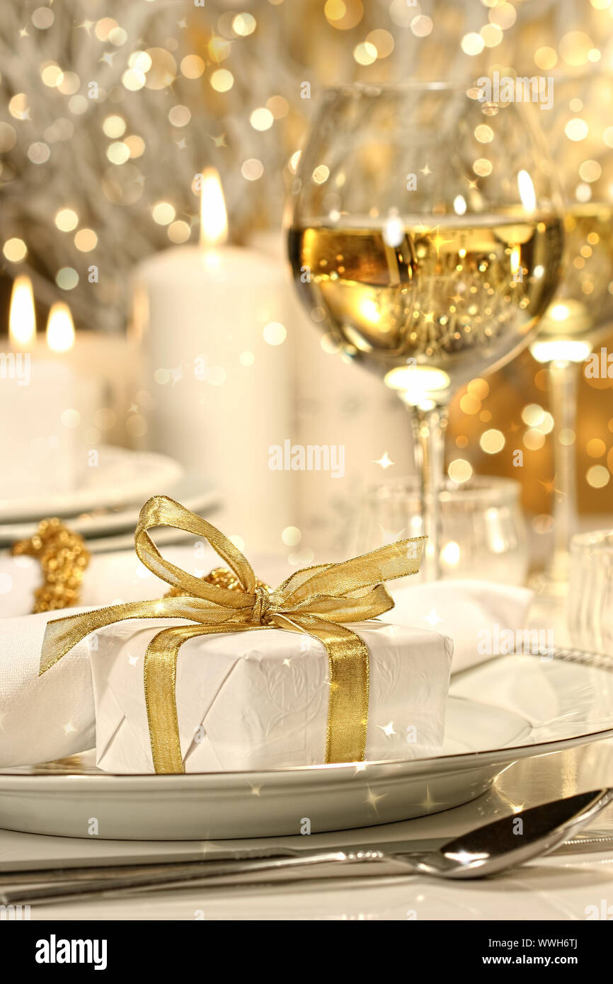 Little gold ribboned gift with gold background Stock Photo - Alamy