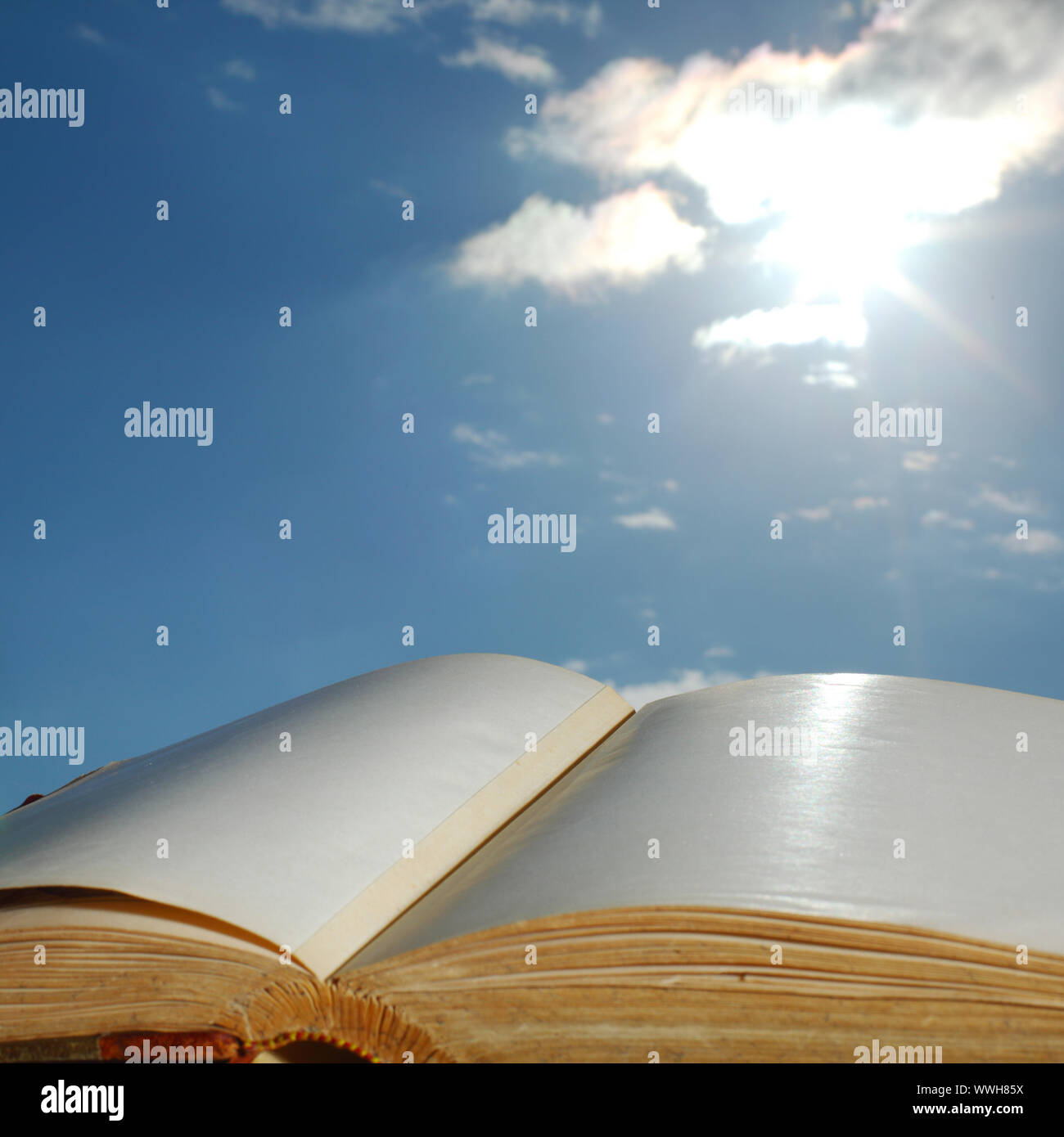 book of wisdom on sun sky background Stock Photo - Alamy