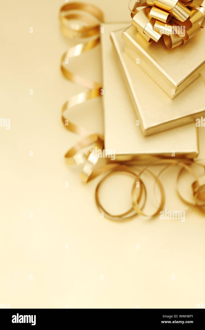 golden christmas gifts on gold background Stock Photo - Alamy