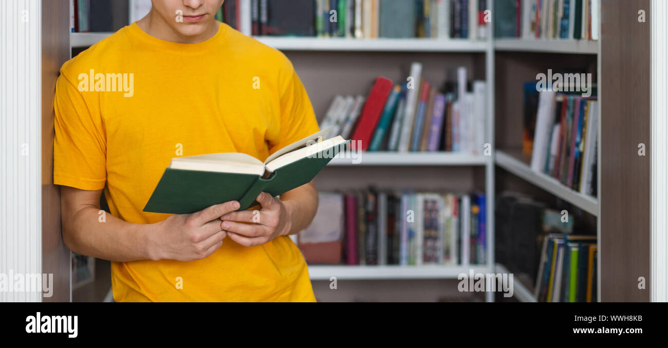 Intelligent student checking on information in handbook Stock Photo - Alamy