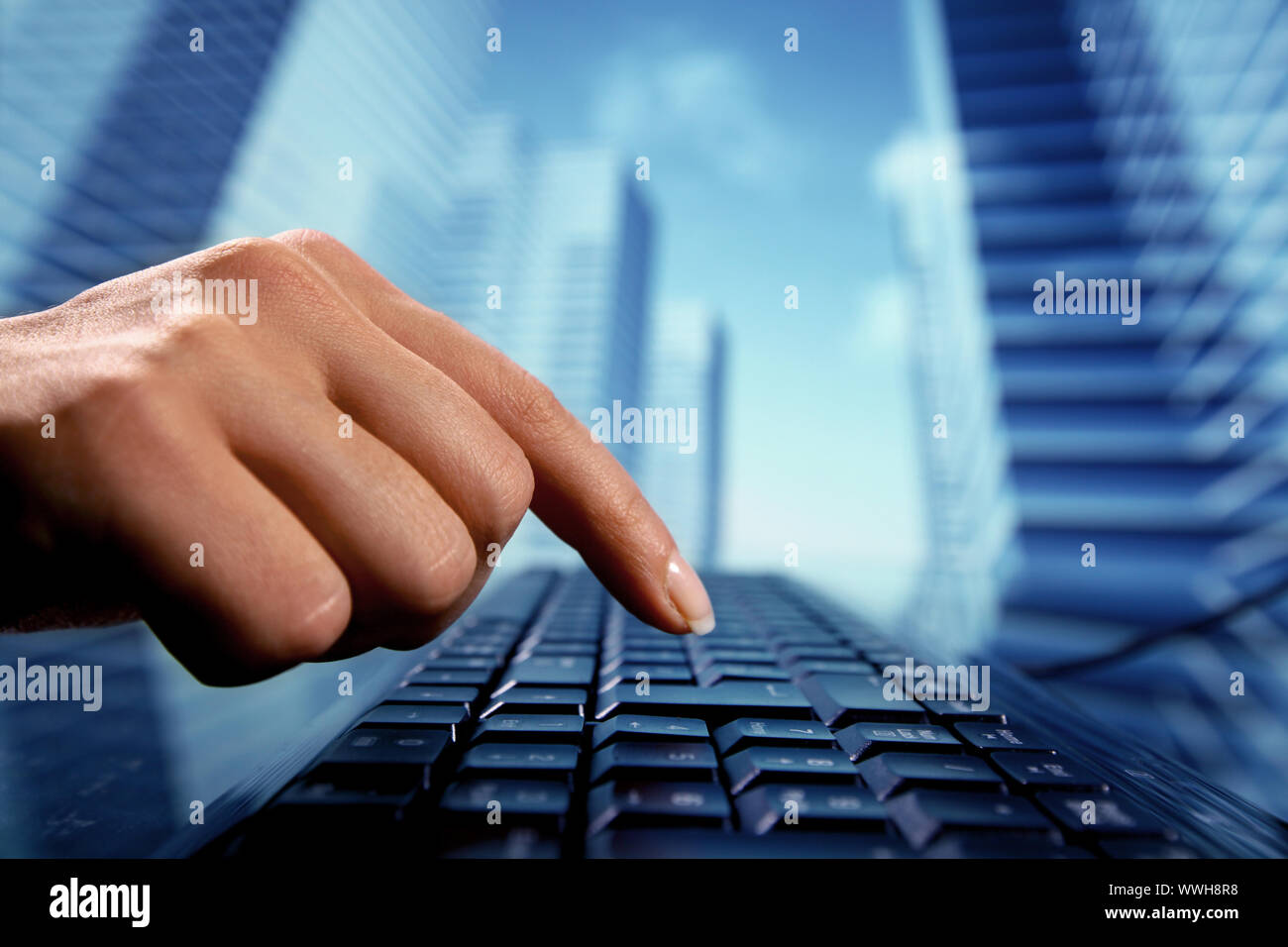 reseller work on keyboard skyscrapers on background Stock Photo - Alamy