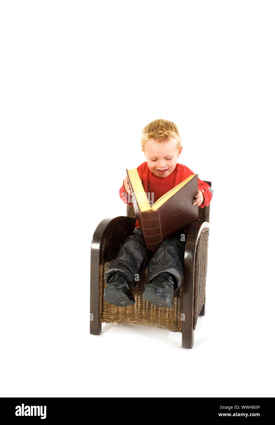 Little boy has fun with heavy book Stock Photo - Alamy
