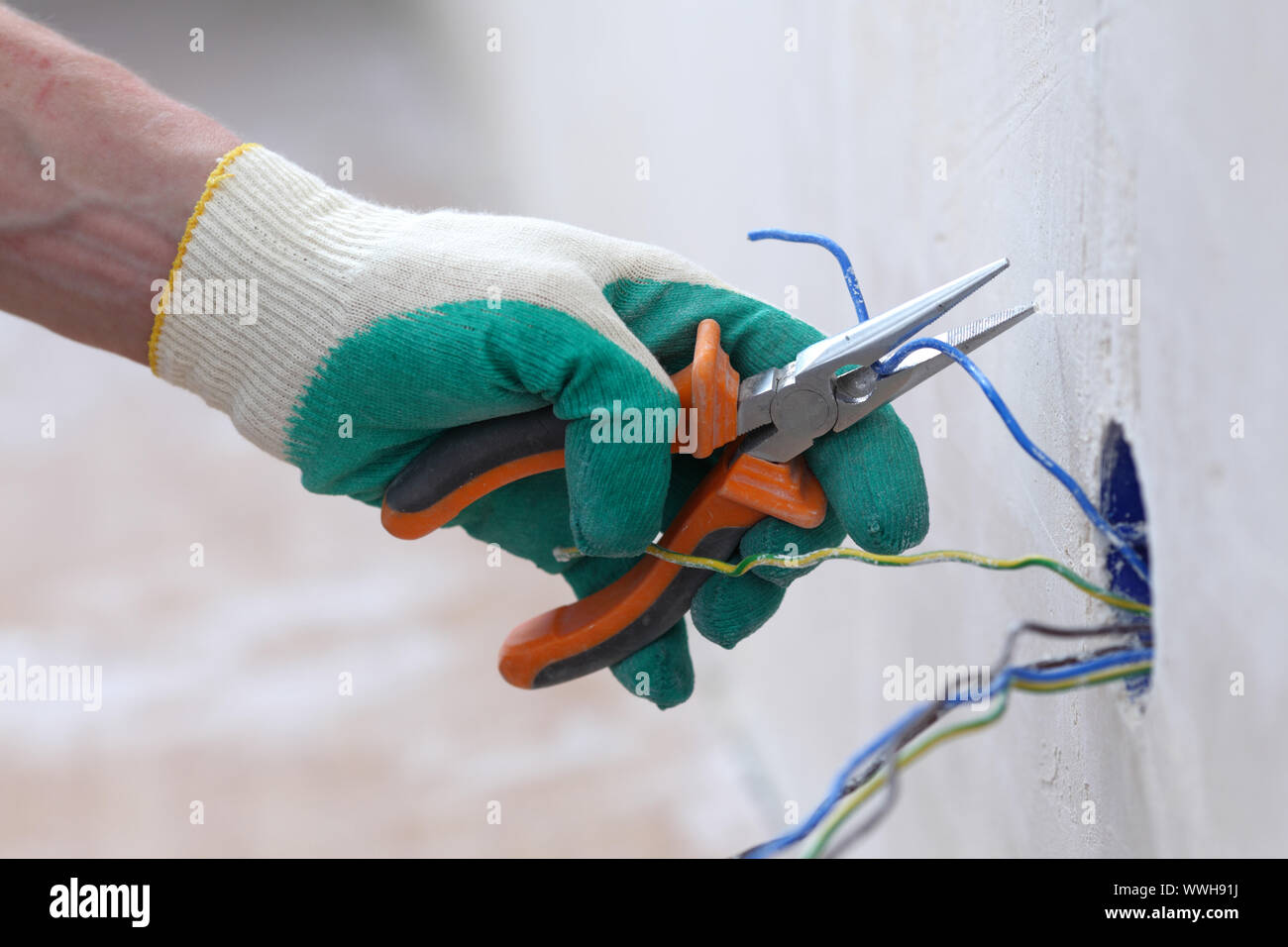 worker puts the wires in the wall Stock Photo - Alamy