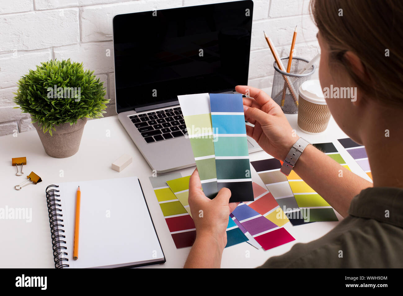 Young woman picking up laptop hi-res stock photography and images - Alamy