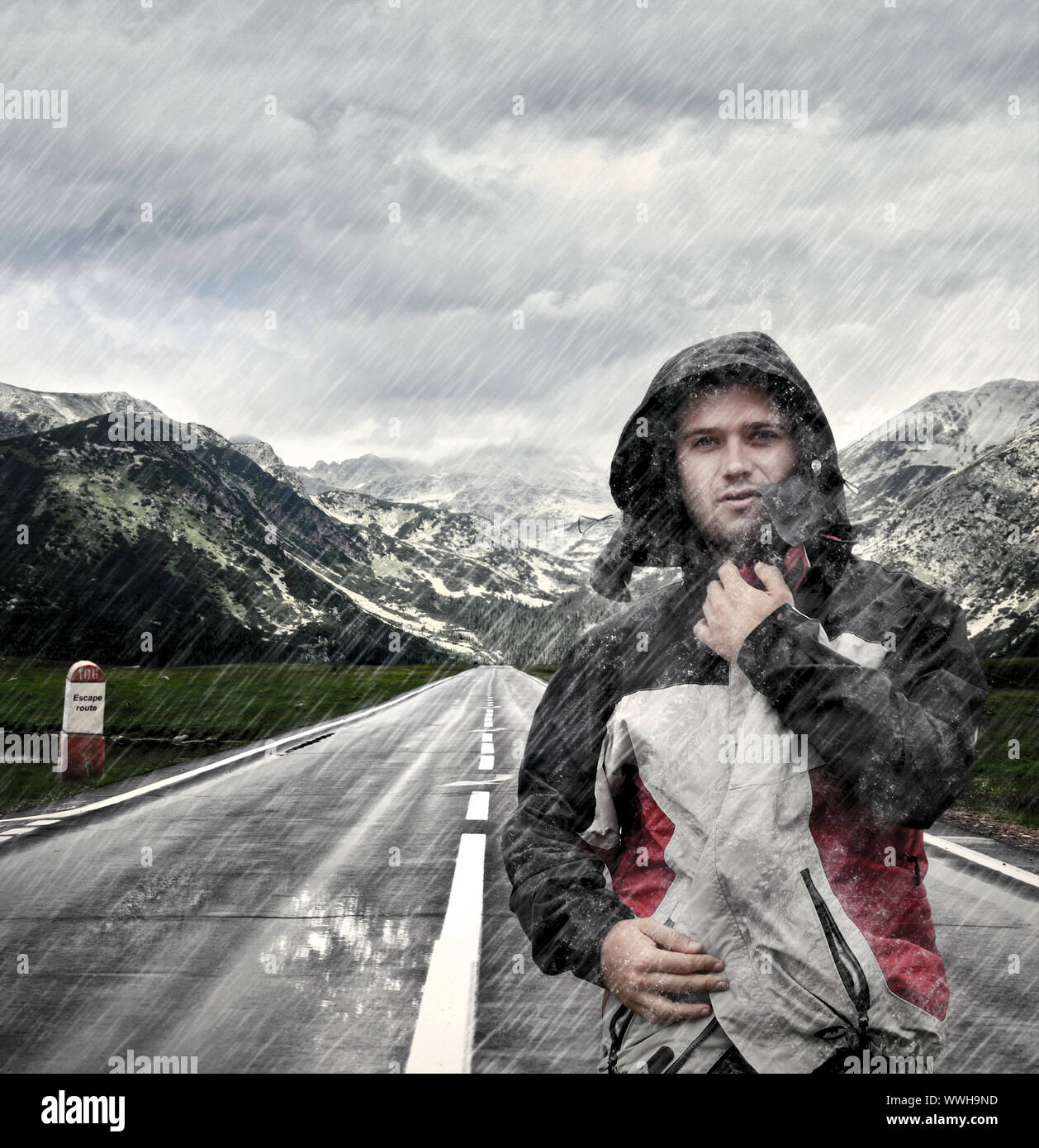 Young man walking on deserted street while is raining Stock Photo - Alamy