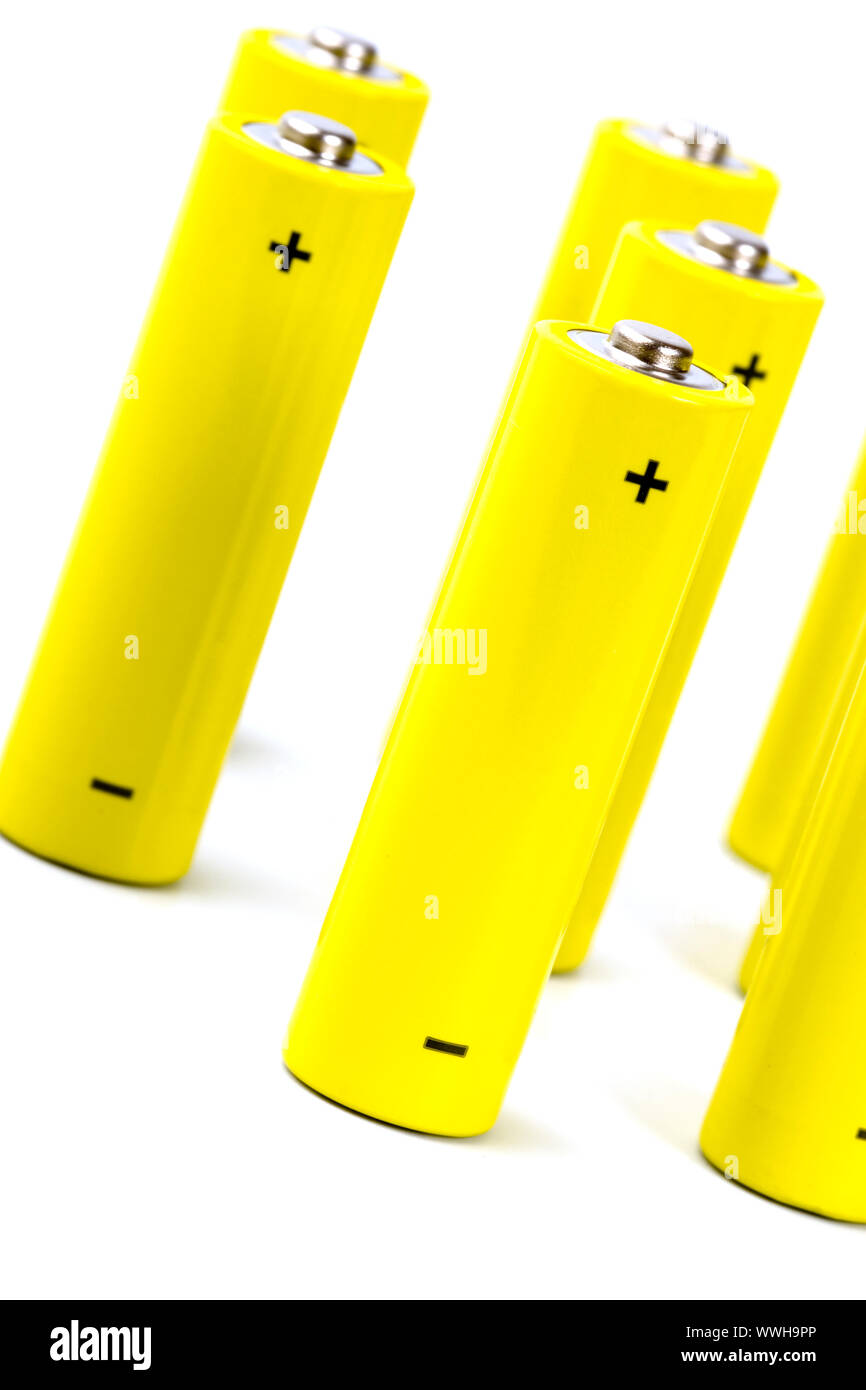 yellow alkaline batteries closeup on white background Stock Photo - Alamy