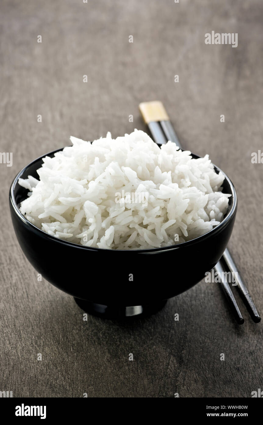 White steamed rice in asian bowl with wooden chopsticks Stock Photo - Alamy