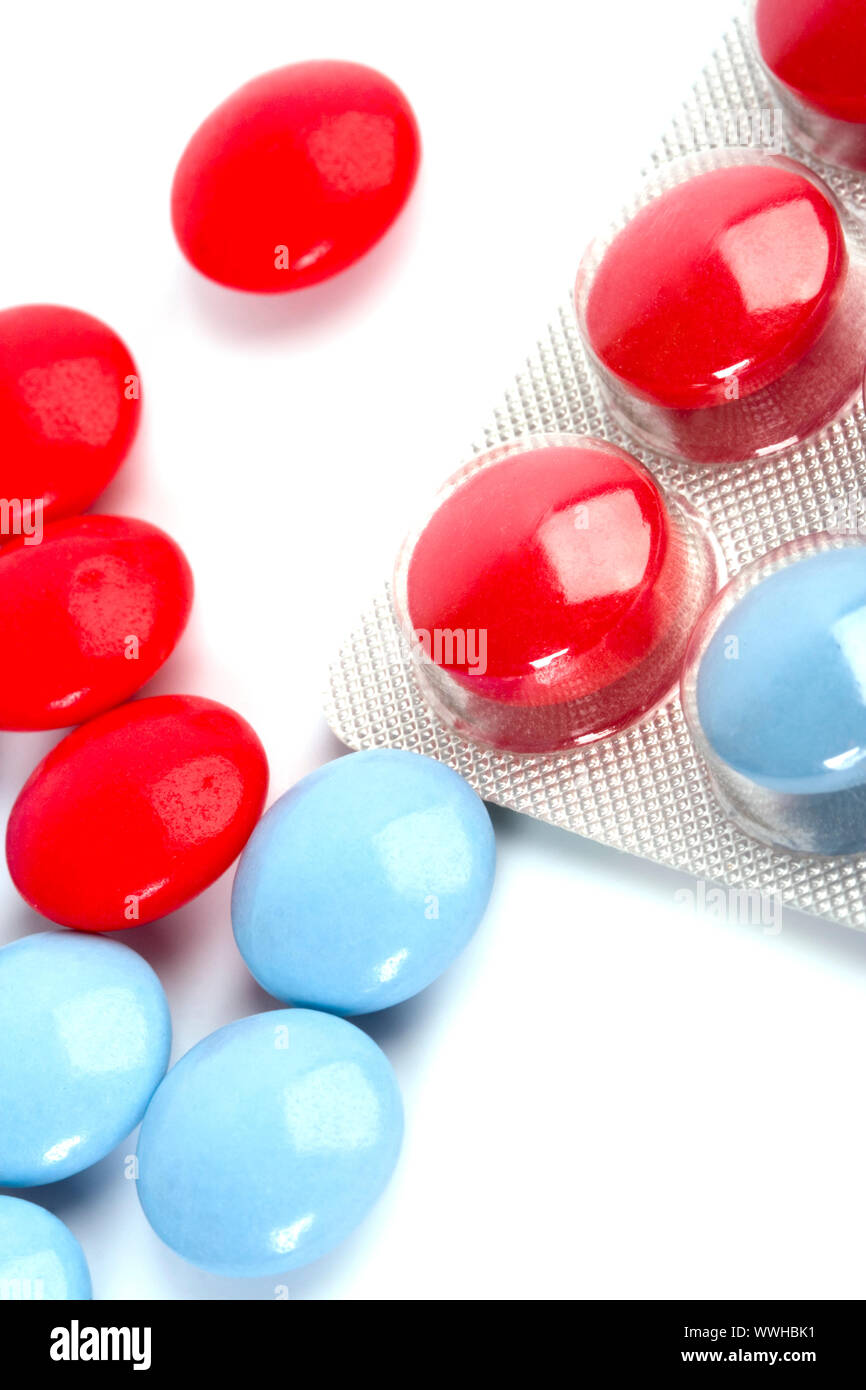 macro image of red and blue pills on white background Stock Photo - Alamy