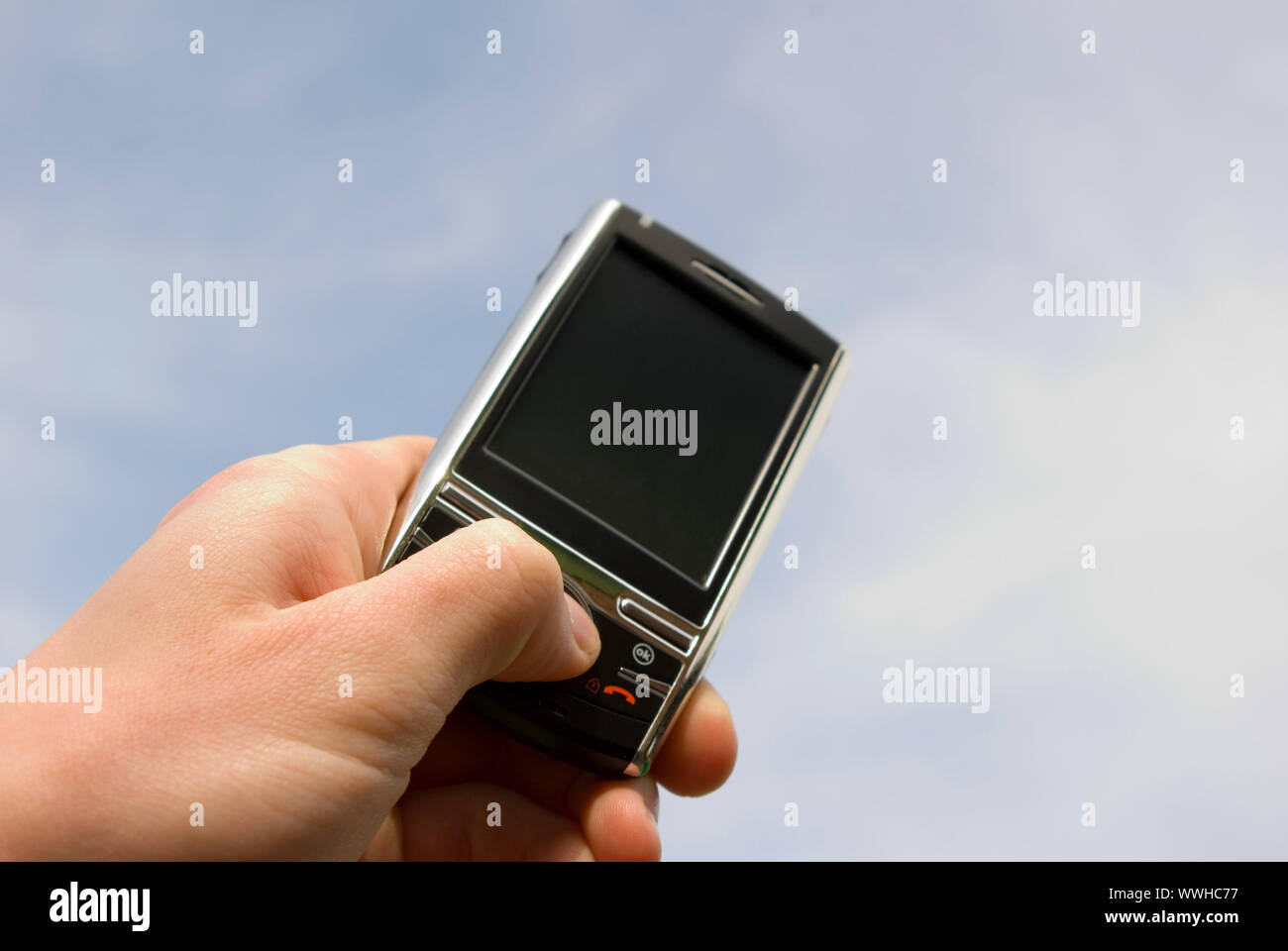 a hand holding a mobile phone for support Stock Photo - Alamy