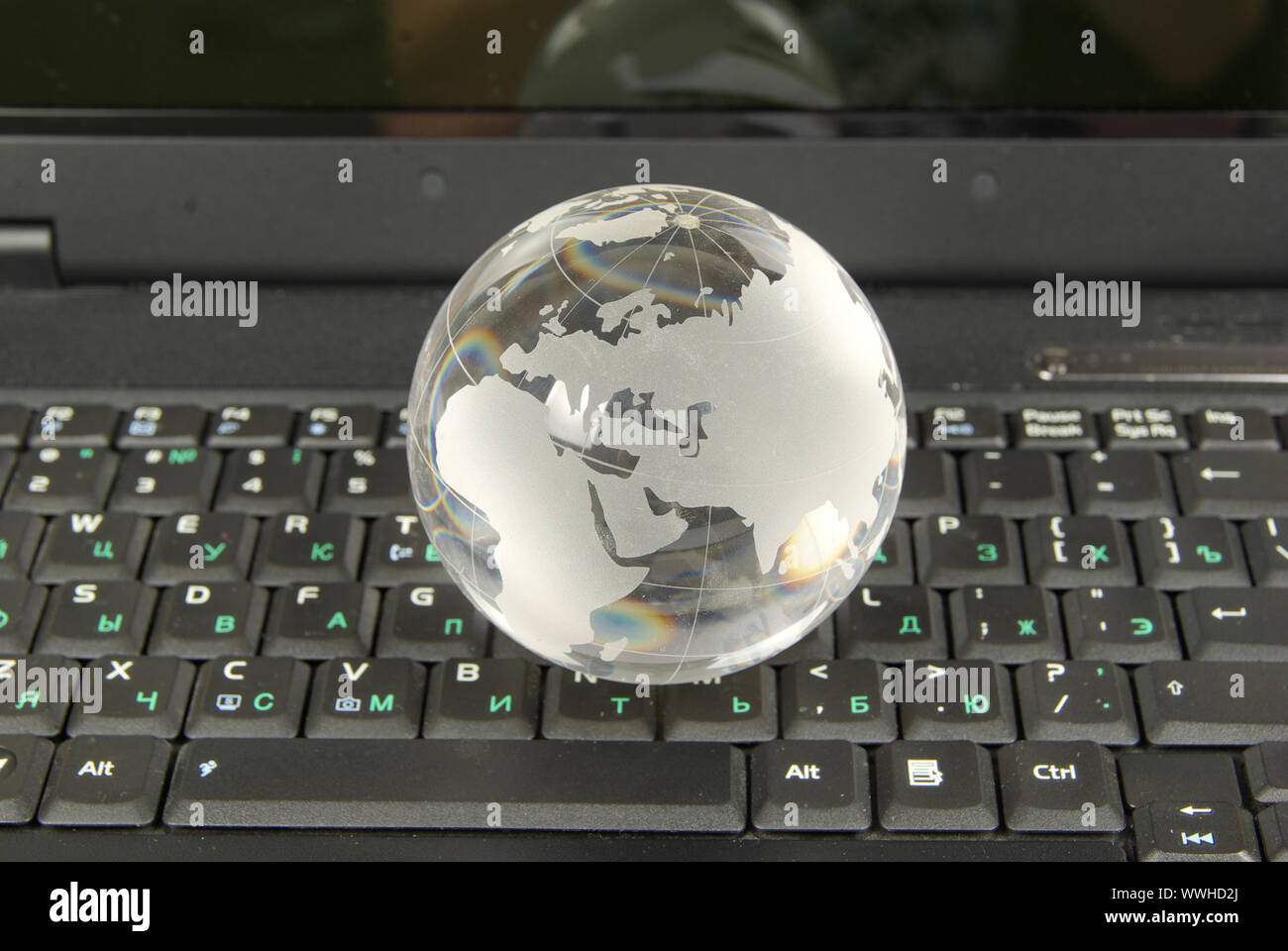 glass globe placed on a laptop Stock Photo - Alamy
