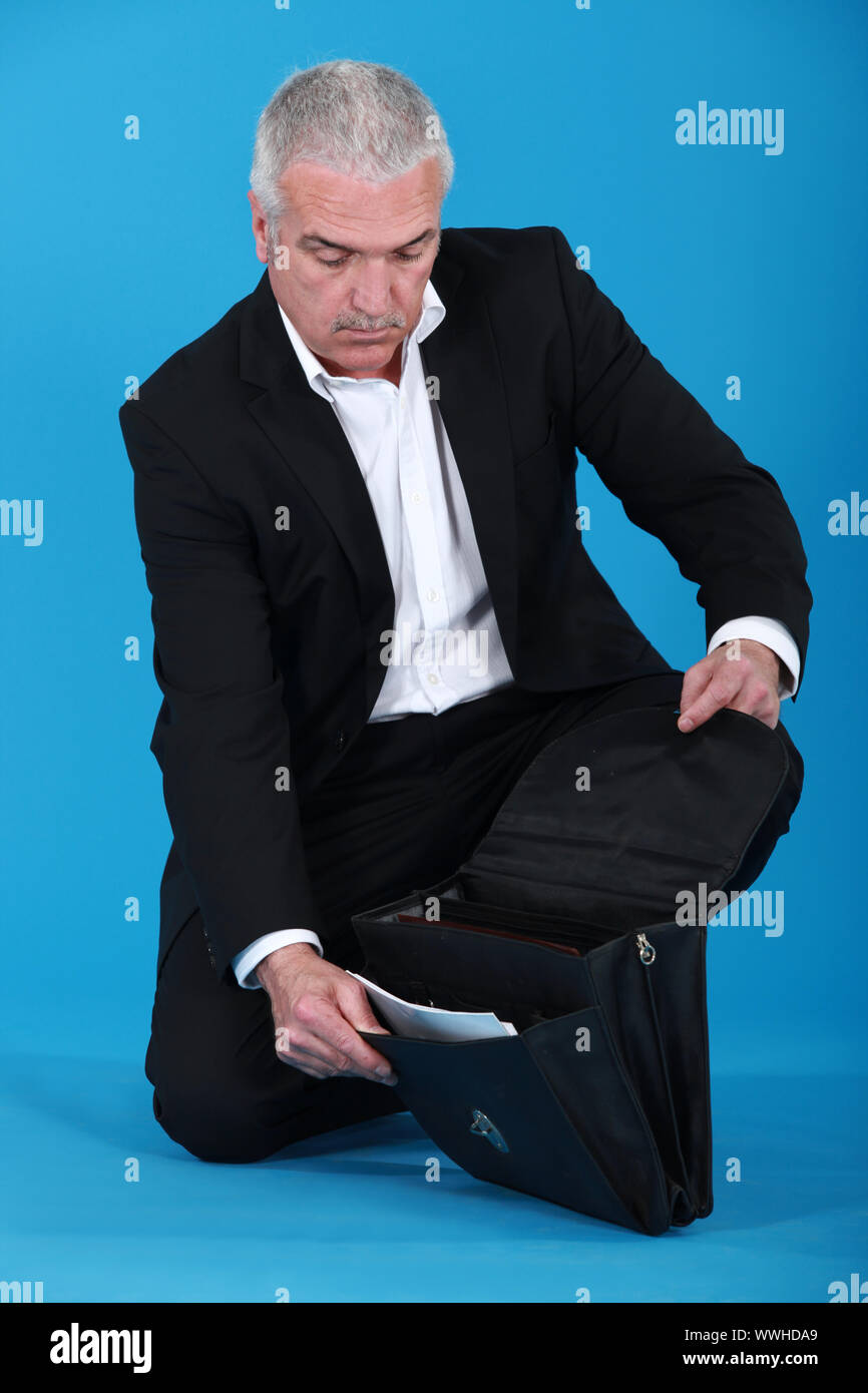 Businessman opening his briefcase Stock Photo - Alamy