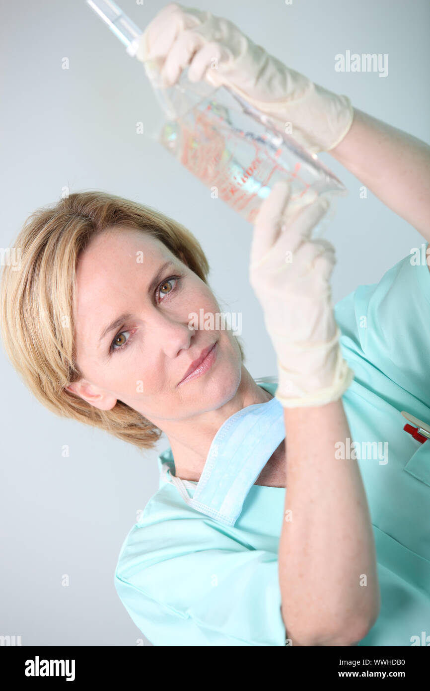 Nurse checking drip Stock Photo - Alamy