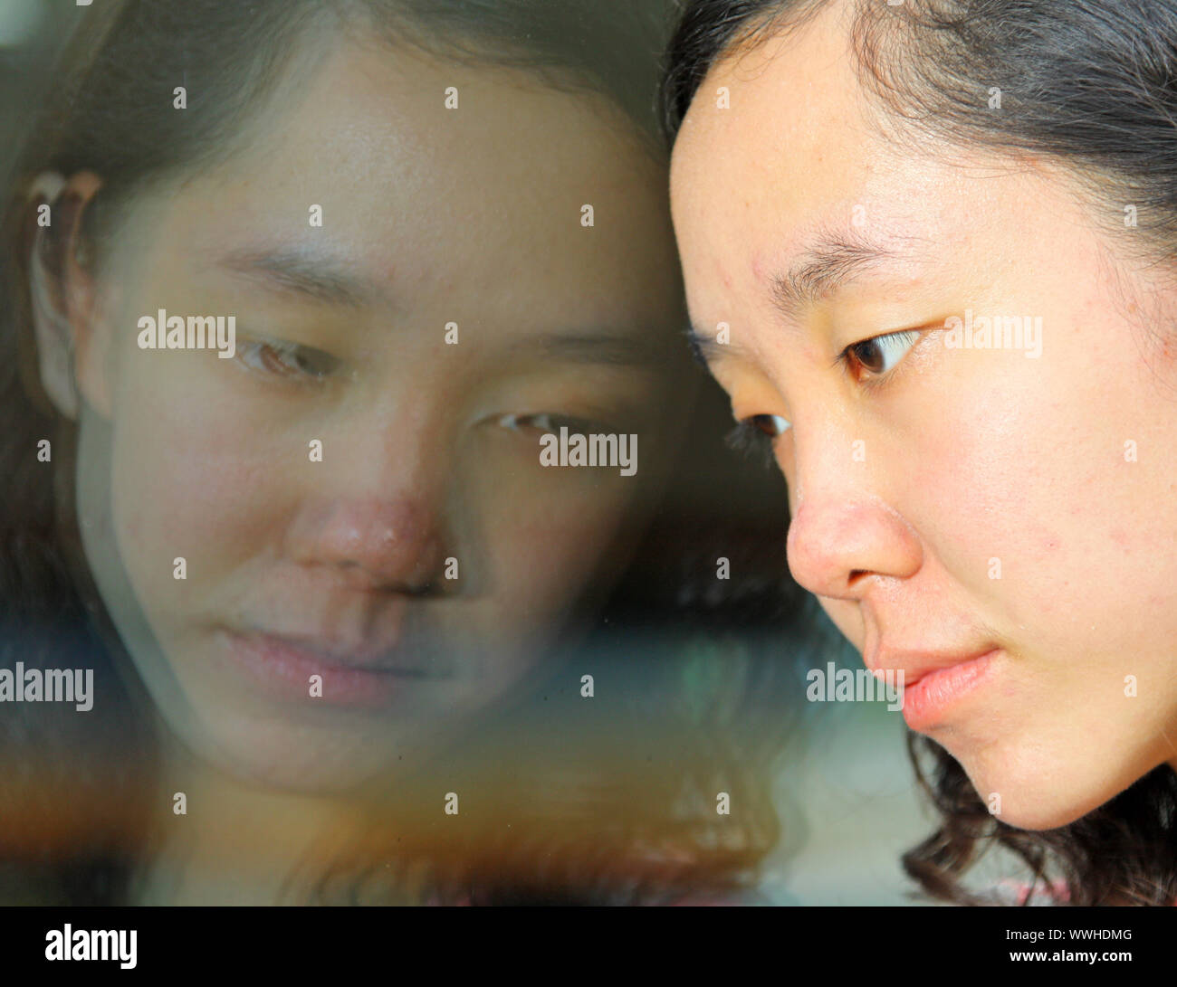 Asian girl with sad face Stock Photo - Alamy