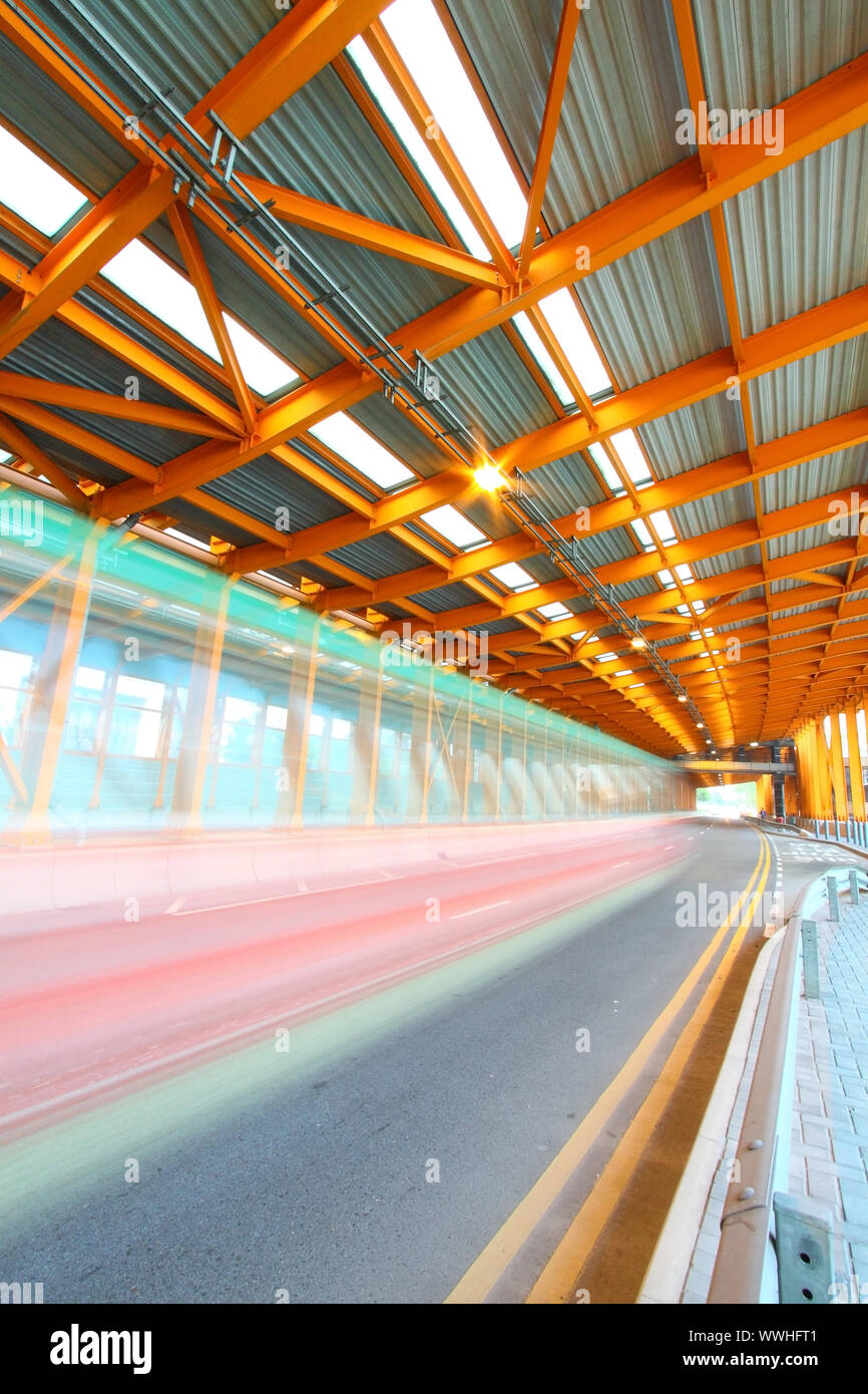 Orange tunnel at daytime with moving bus Stock Photo - Alamy