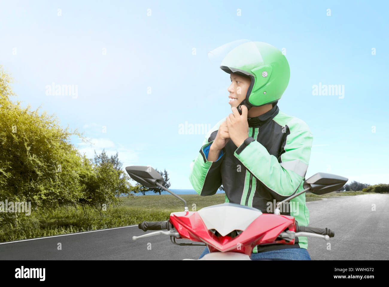 Asian motorcycle taxi man with his motorcycle on the asphalt road Stock ...