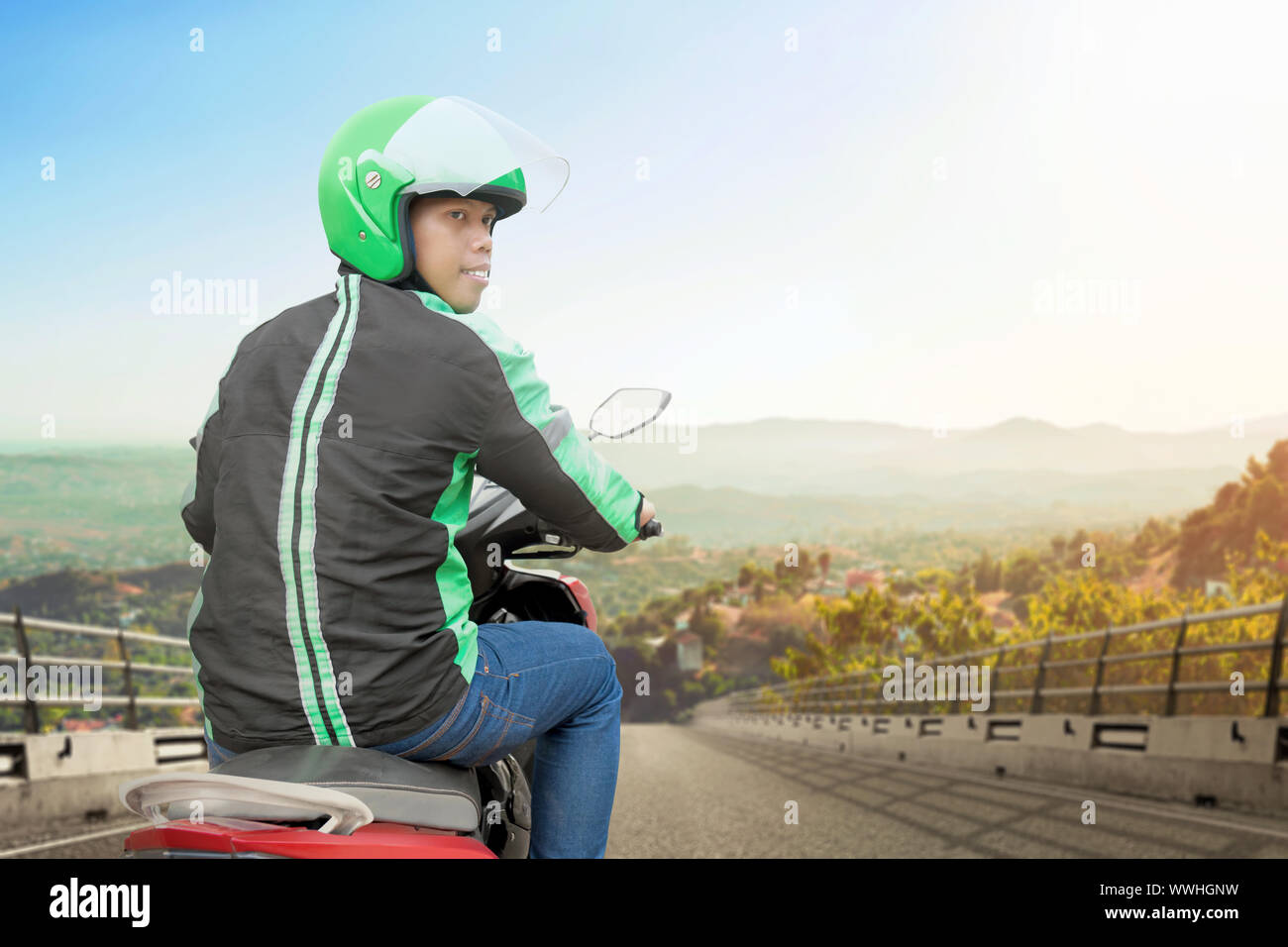 Asian motorcycle taxi man with his motorcycle on the asphalt road Stock ...