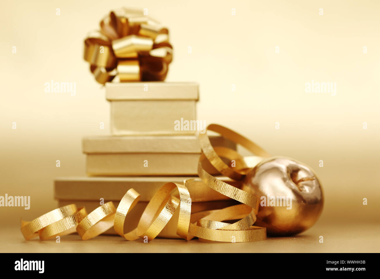 golden christmas gifts on gold background Stock Photo - Alamy