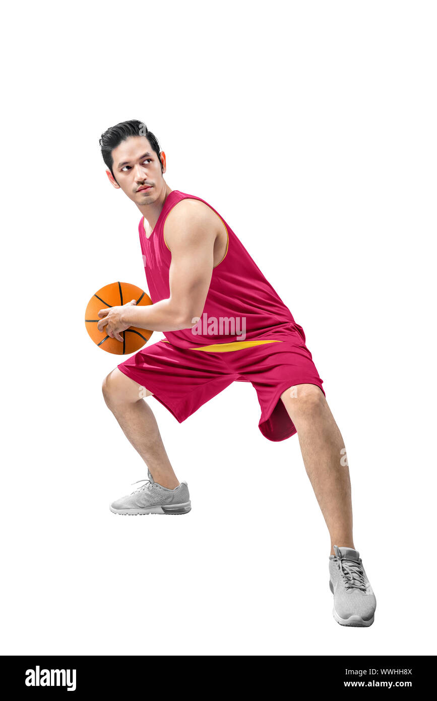 Asian man playing basketball in action posing isolated over white ...