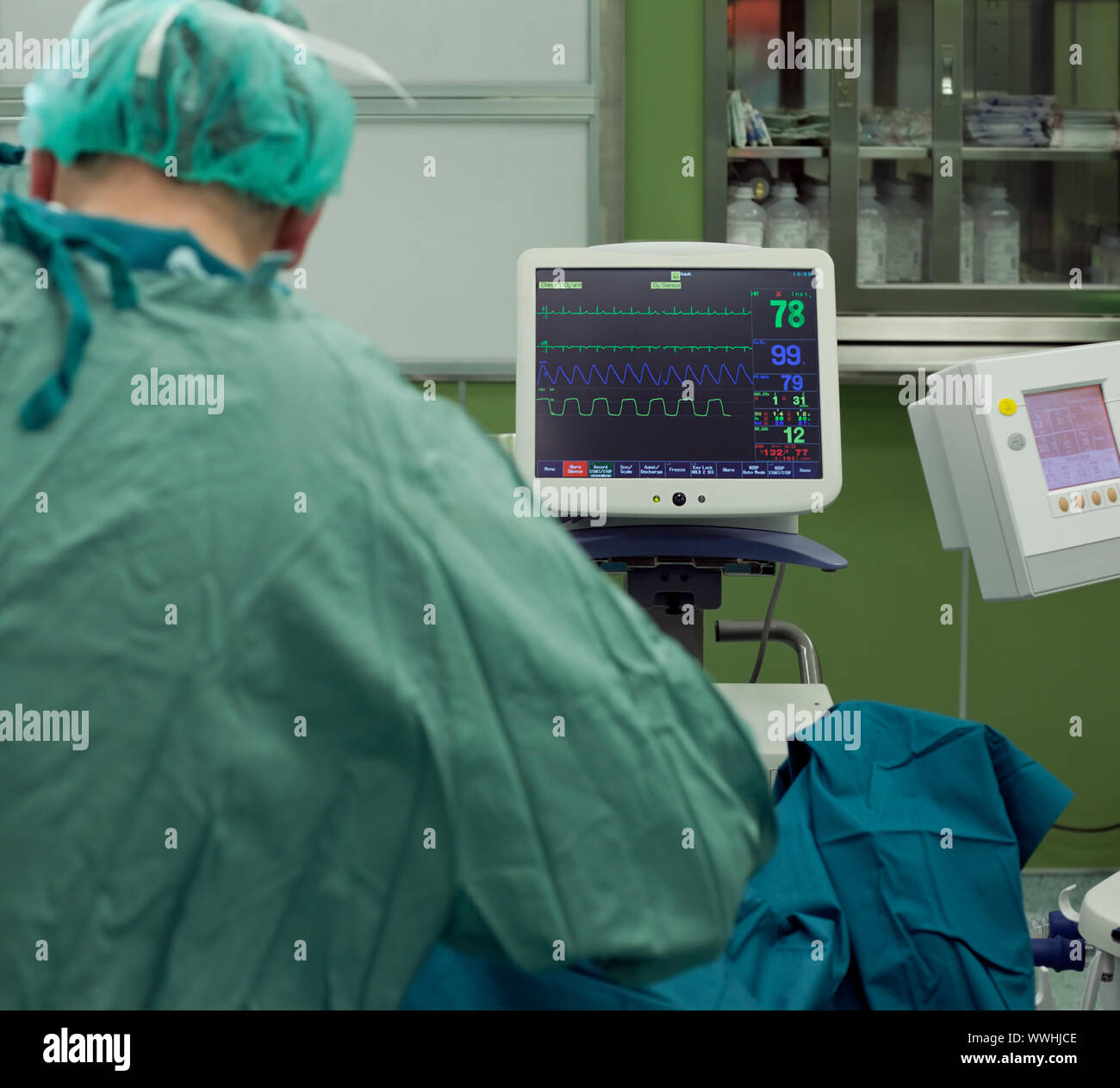 cardiogram monitor in surgery while doctor operates on patient Stock ...