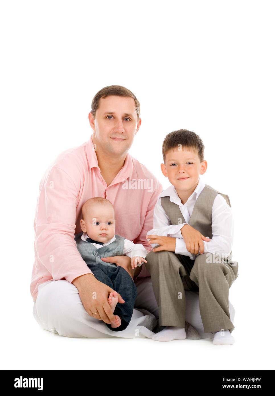 Father and two young sons sitting together Stock Photo - Alamy