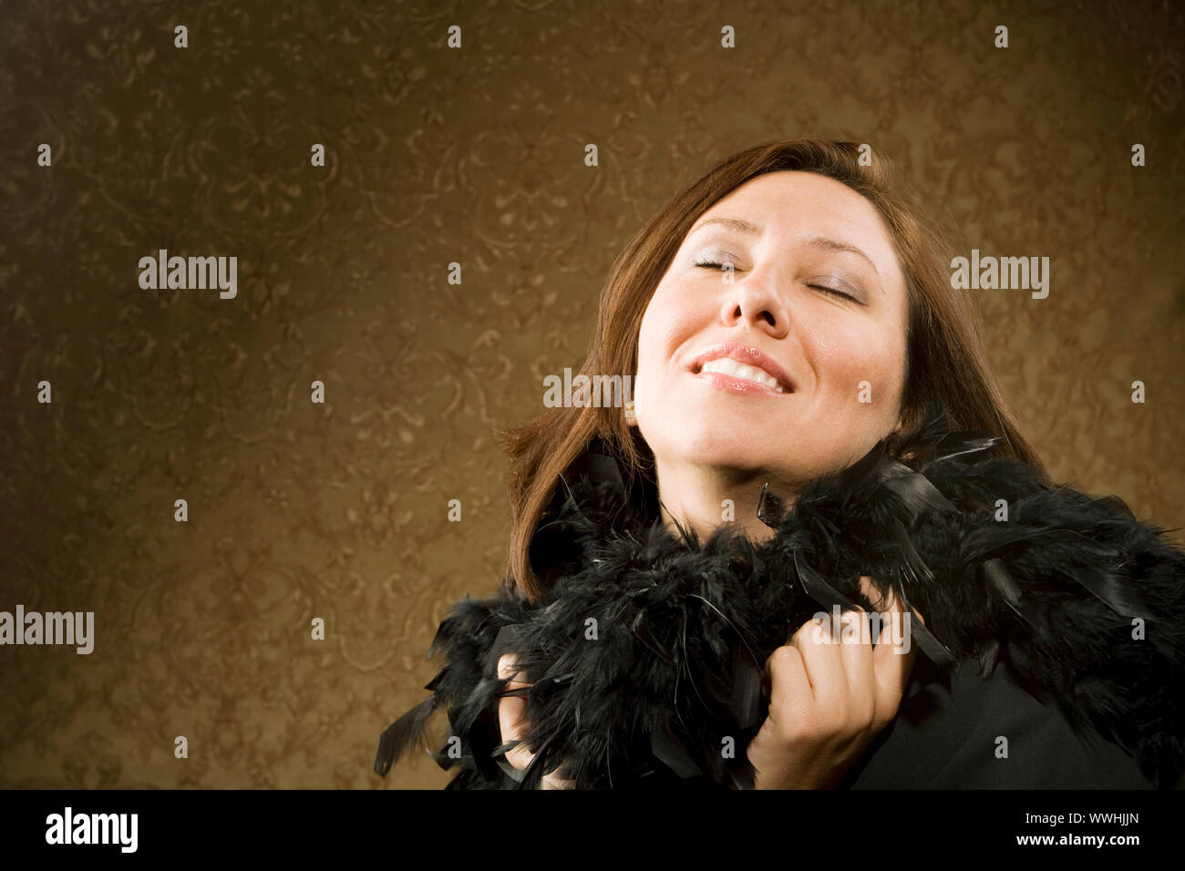 Woman wearing feather boa hi-res stock photography and images - Alamy