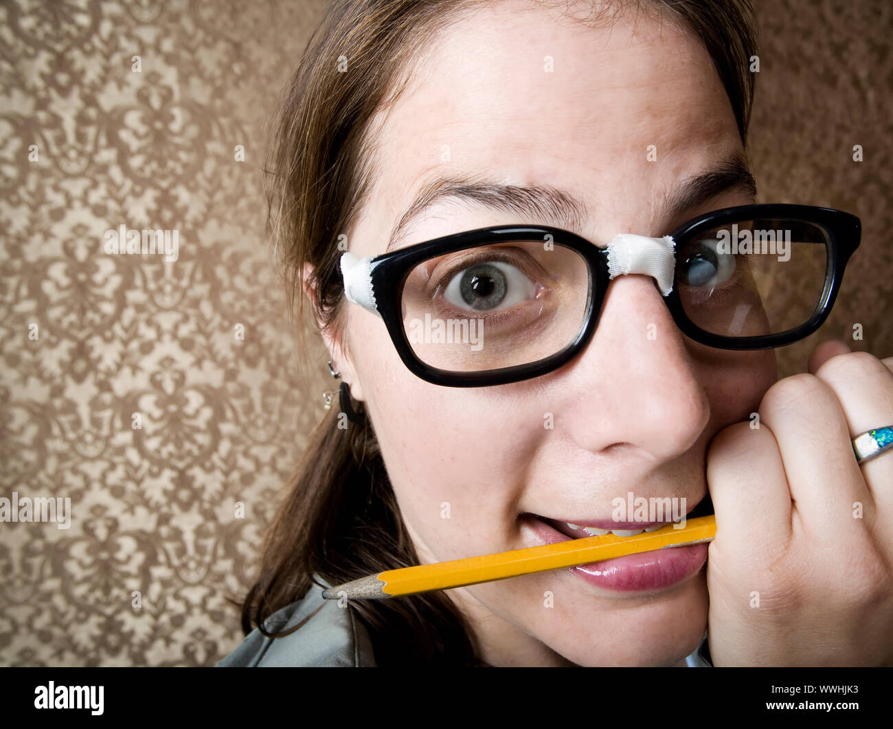 Nervous nerdy Woman Chewing on a Yellow Pencil Stock Photo - Alamy