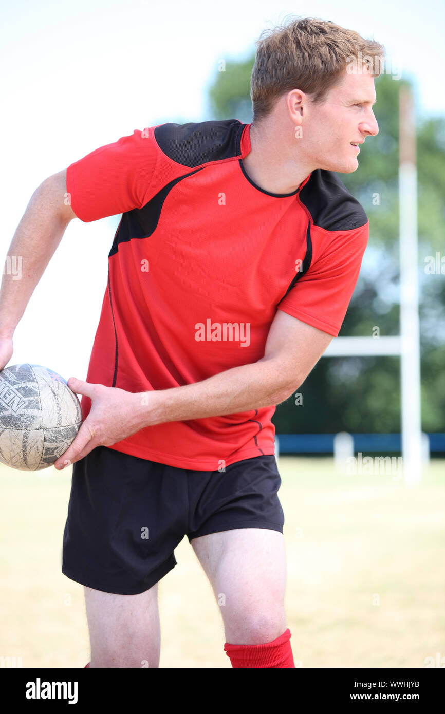 Rugby player passing ball Stock Photo - Alamy