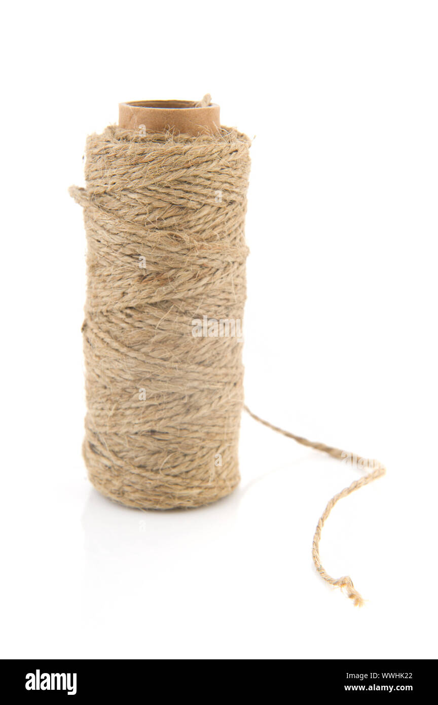 Brown spool with sisal rope on white background Stock Photo - Alamy