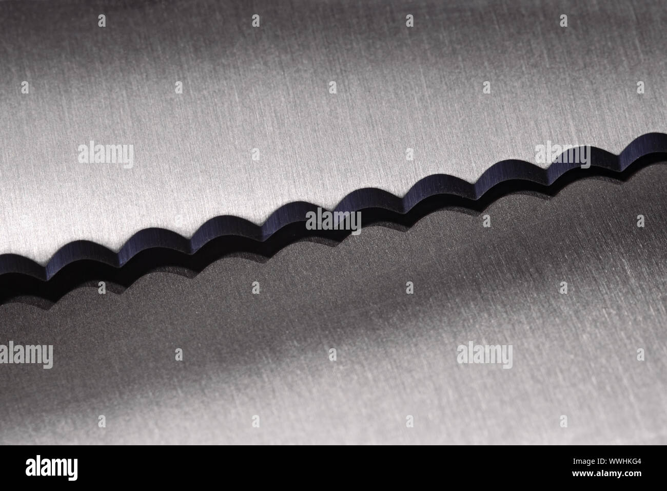 Macro photo of a serrated kitchen knife Stock Photo - Alamy