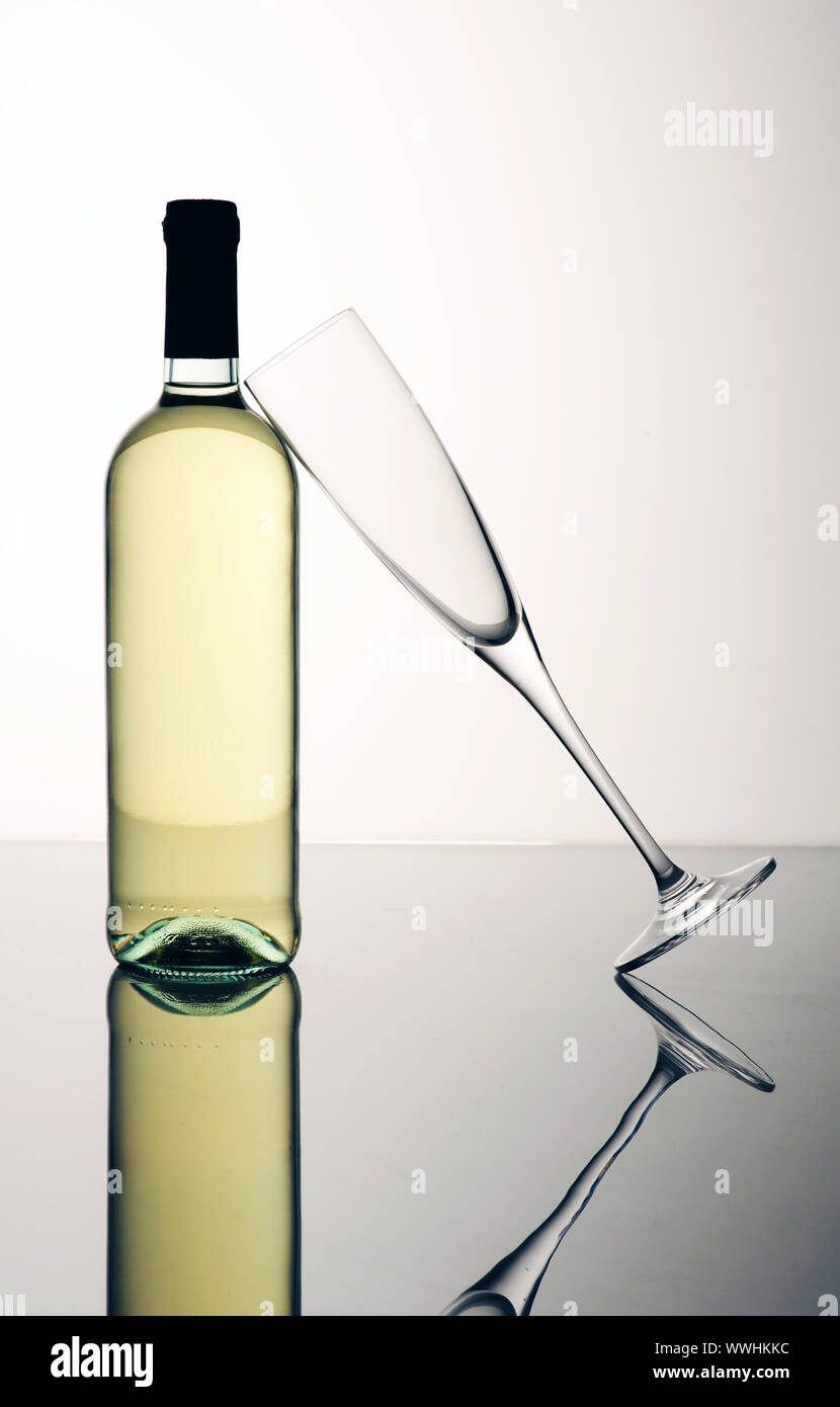 bottle and glass on a reflective surface Stock Photo - Alamy