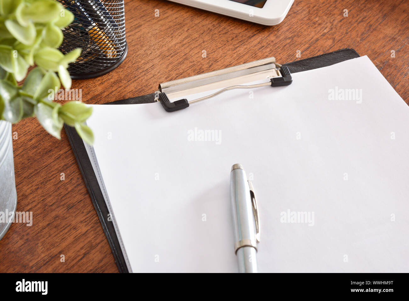Folder with blank sheets on desk. Horizontal composition. Elevated view ...
