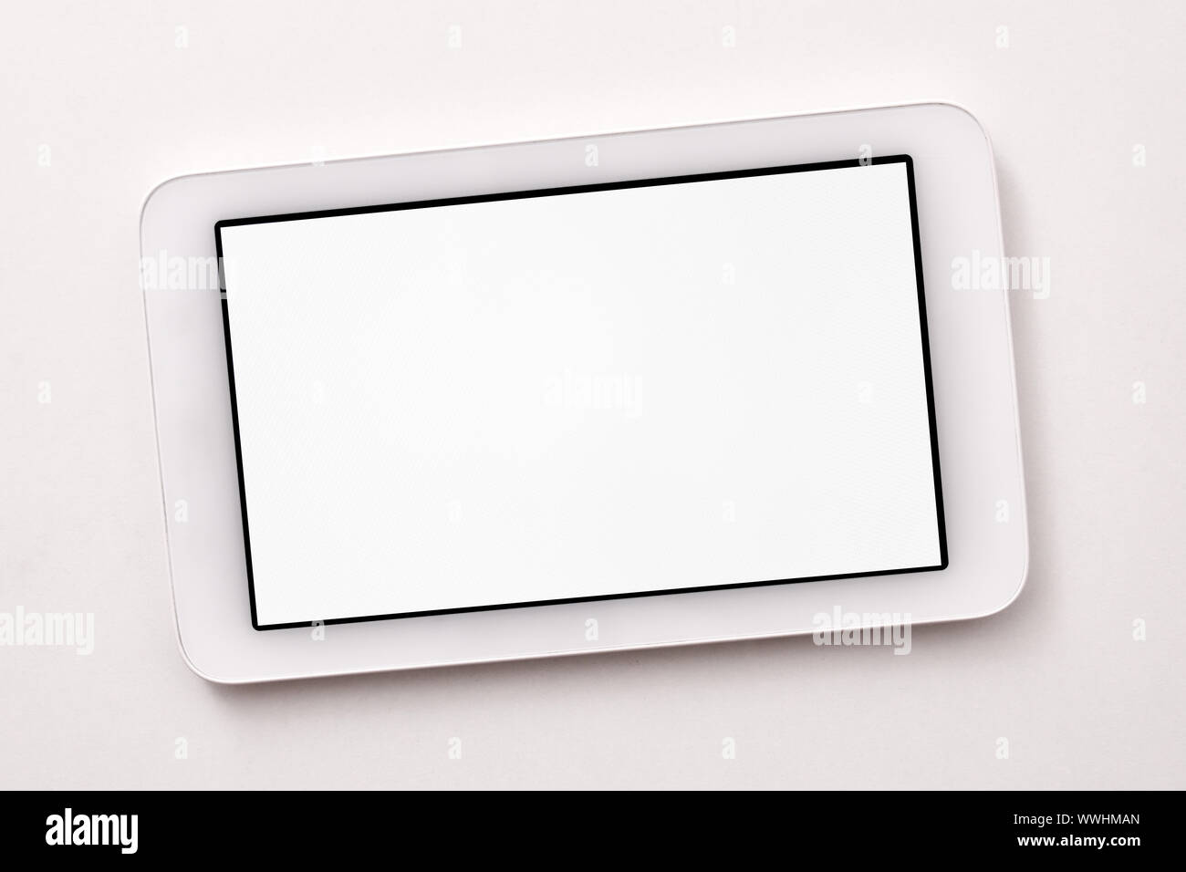 White tablet with white screen on white table close up. Horizontal ...