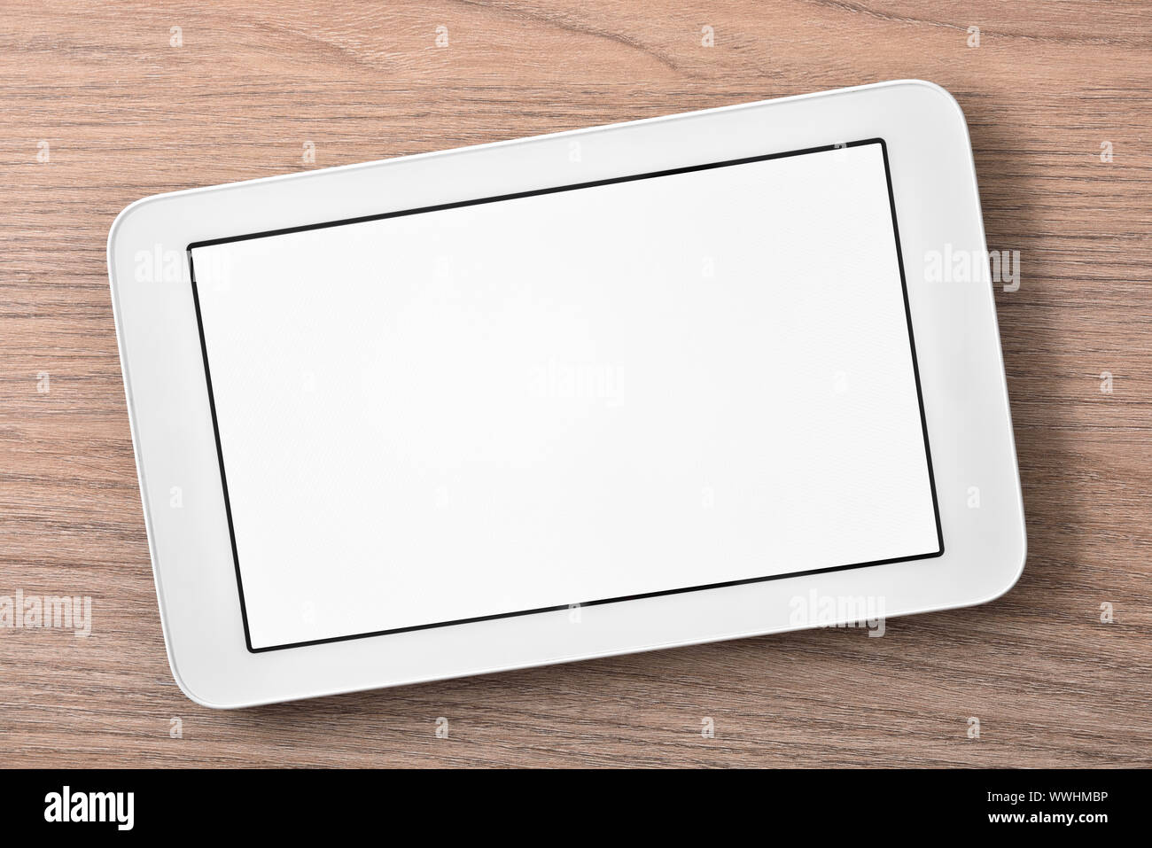 White tablet with white screen on wood table close up. Horizontal ...