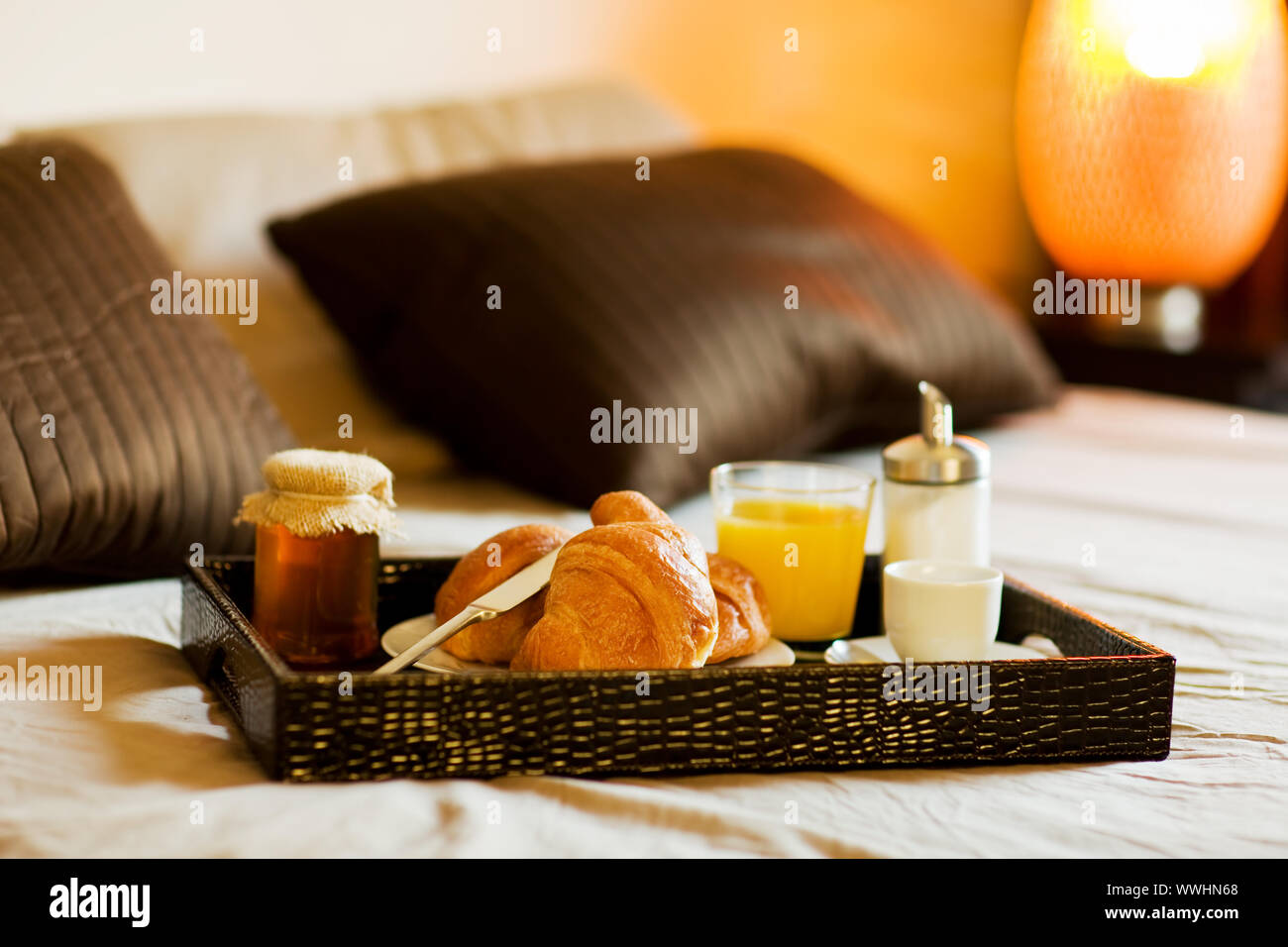 photo of tray with breakfast food on the bed inside a bedroom Stock ...