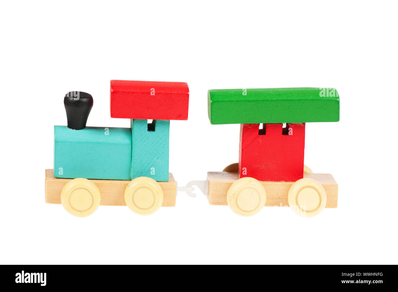 Little wooden toy train isolated over white background Stock Photo - Alamy