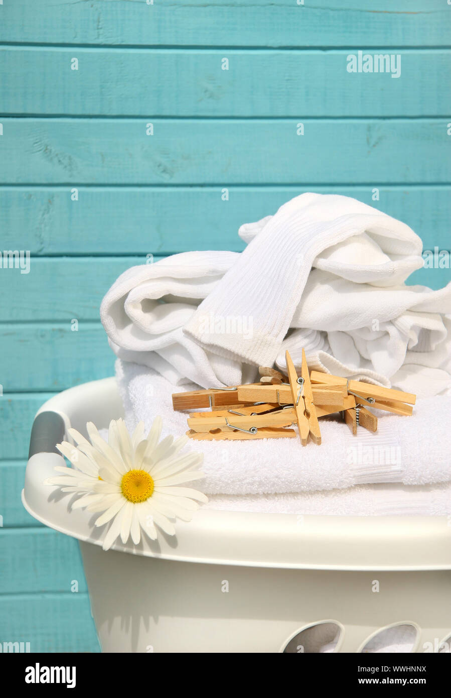 White laundry basket with folded towels and socks Stock Photo - Alamy