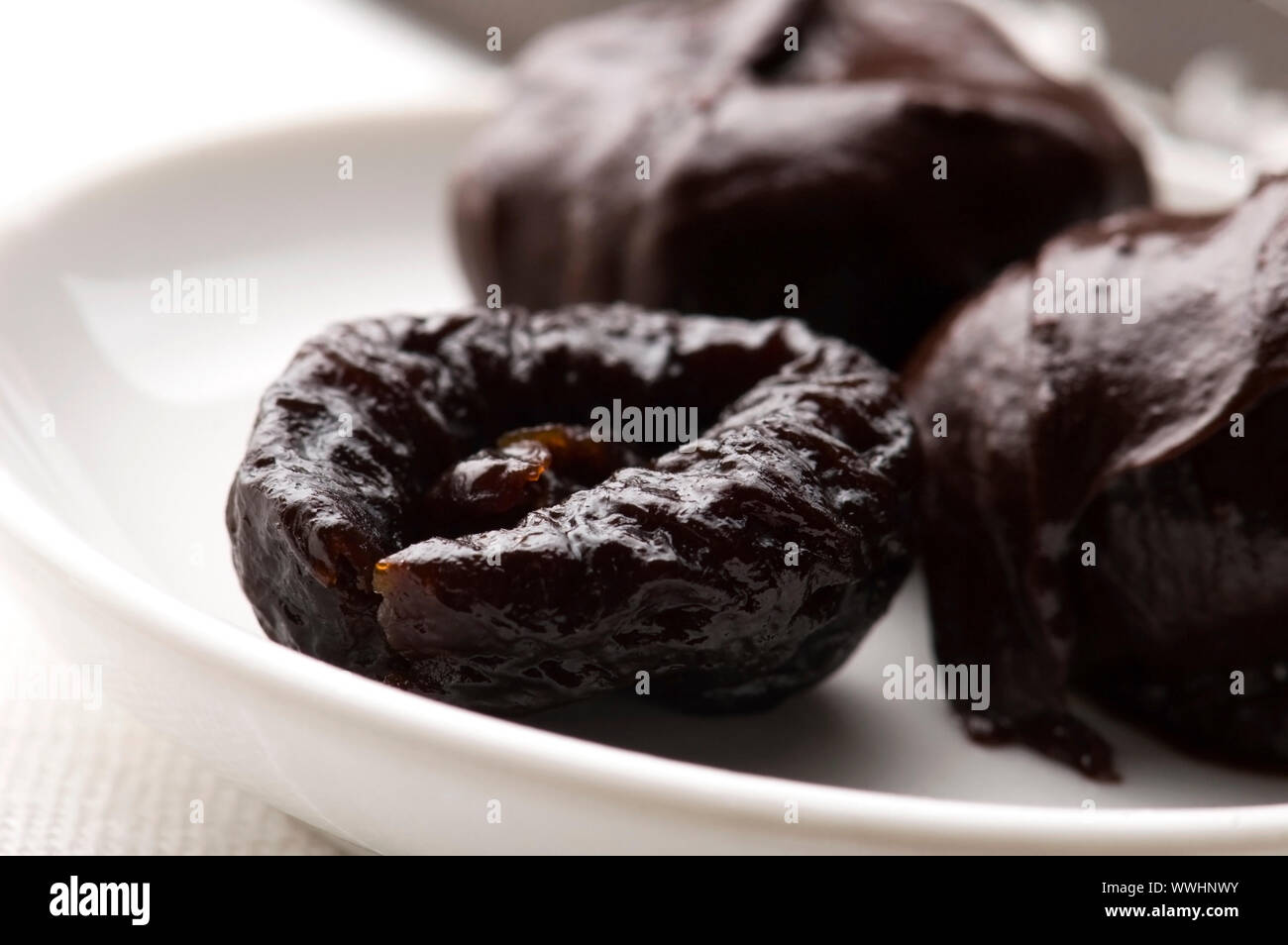 Dried plums in chocolate Stock Photo - Alamy
