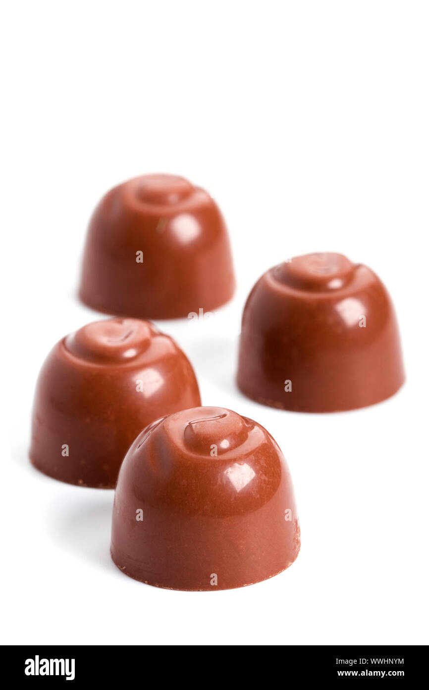 four chocolate sweets isolated on a white background Stock Photo - Alamy