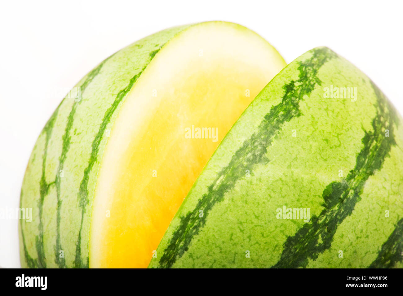 Bright yellow and green watermelon on a white background Stock Photo ...