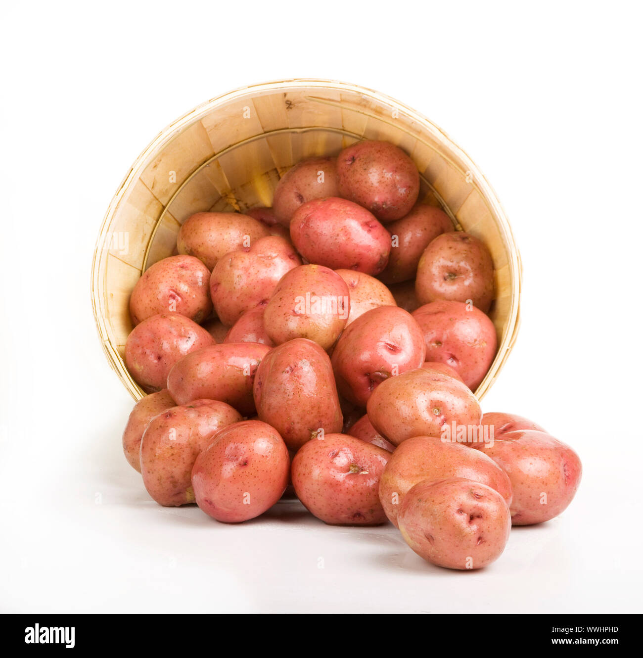 Red Potatoes pouring out of a Woven Basket Stock Photo - Alamy