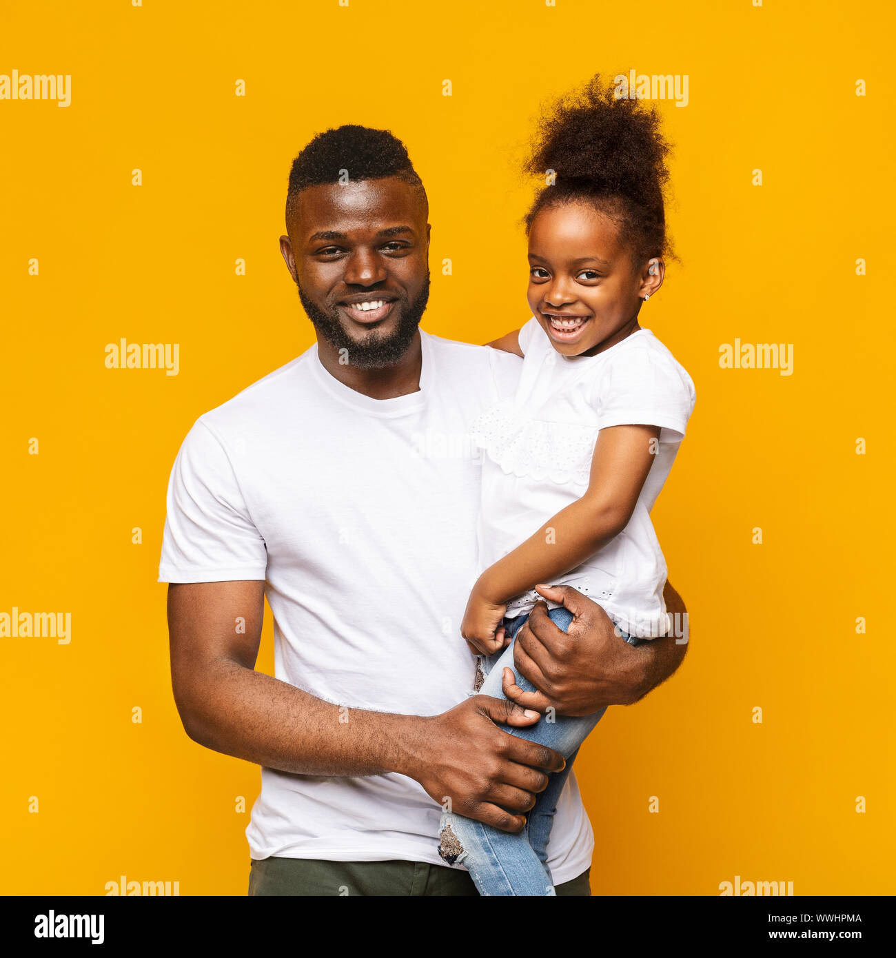 Cheerful african dad holding his cute little daughter on hands Stock ...