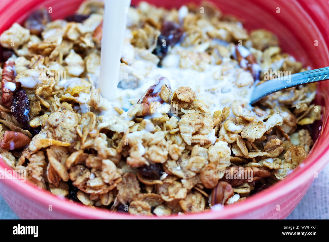 Milk pouring on crunchy granola hi-res stock photography and images - Alamy
