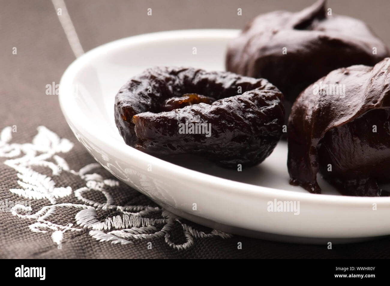 Dried plums in chocolate Stock Photo - Alamy
