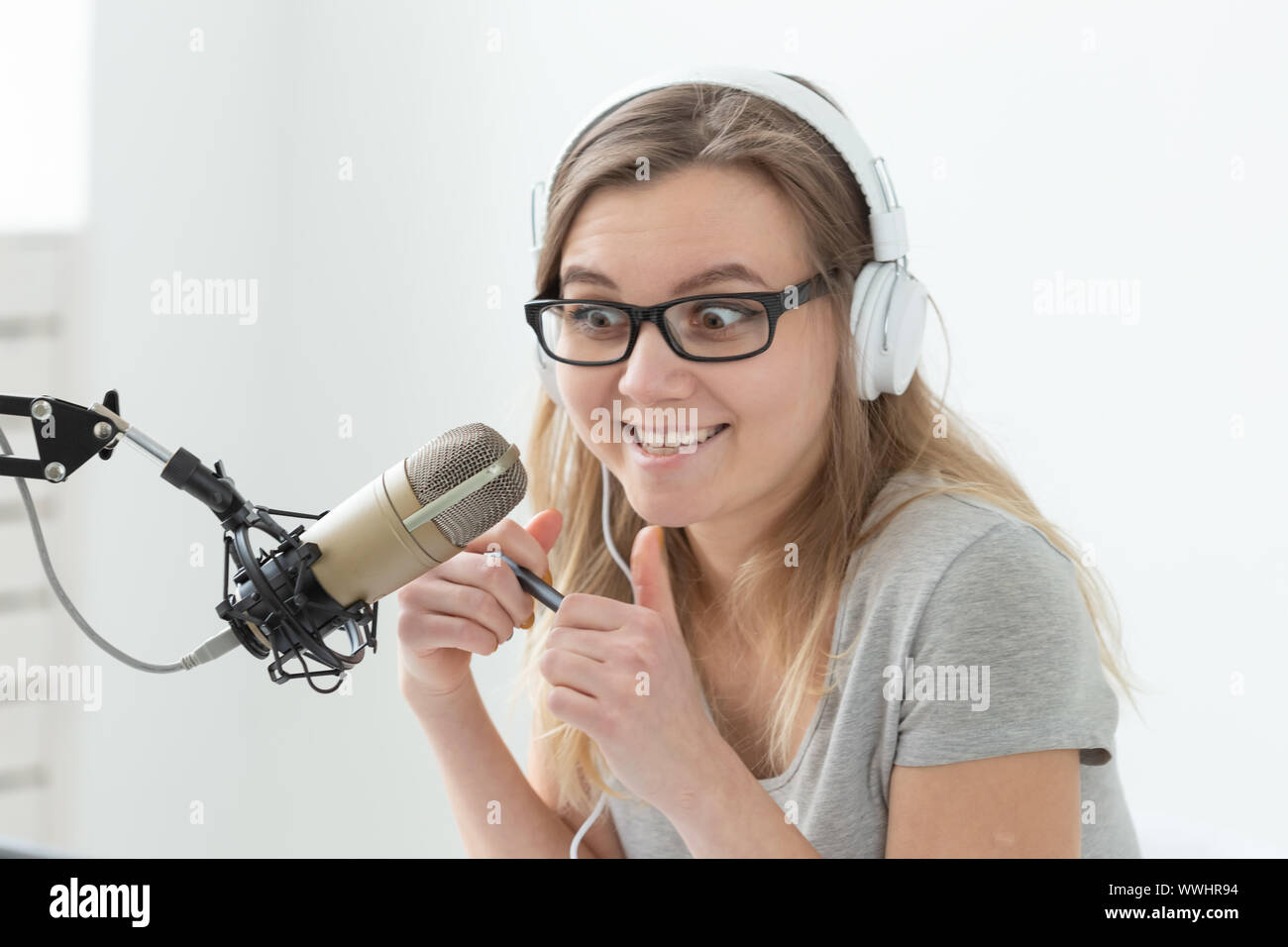 Radio host concept - Funny woman working as radio host sitting in front ...